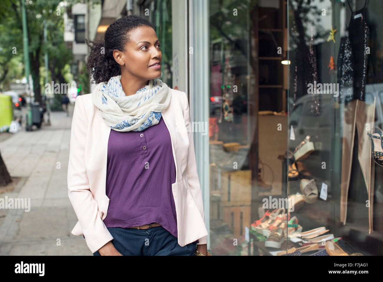 Woman looking at shop window Stock Photo - Alamy