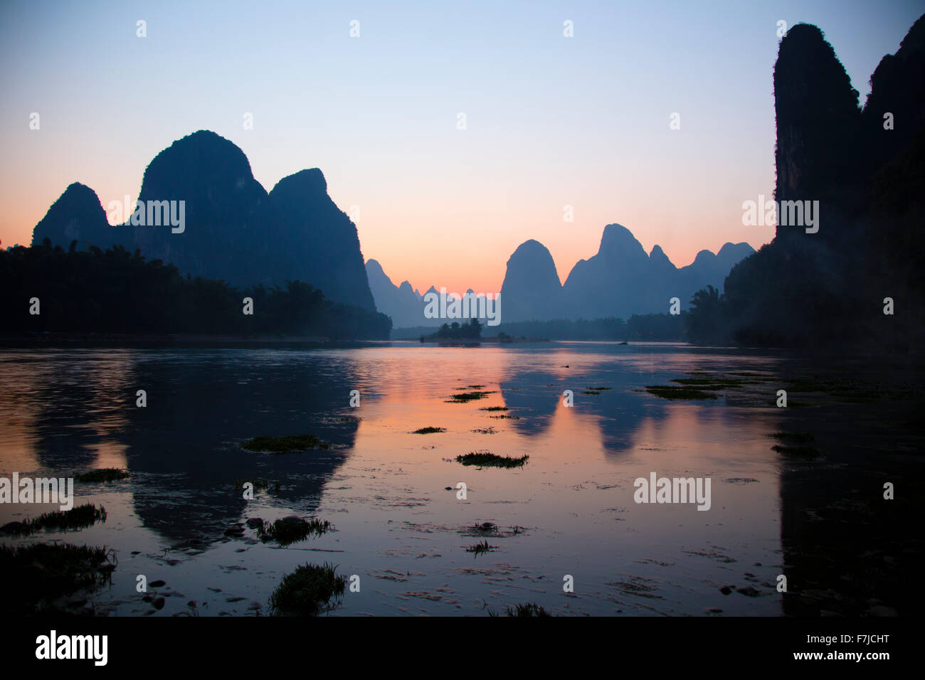 Limestone Karst Formations reflected in River Li at Sunset Guilin ...
