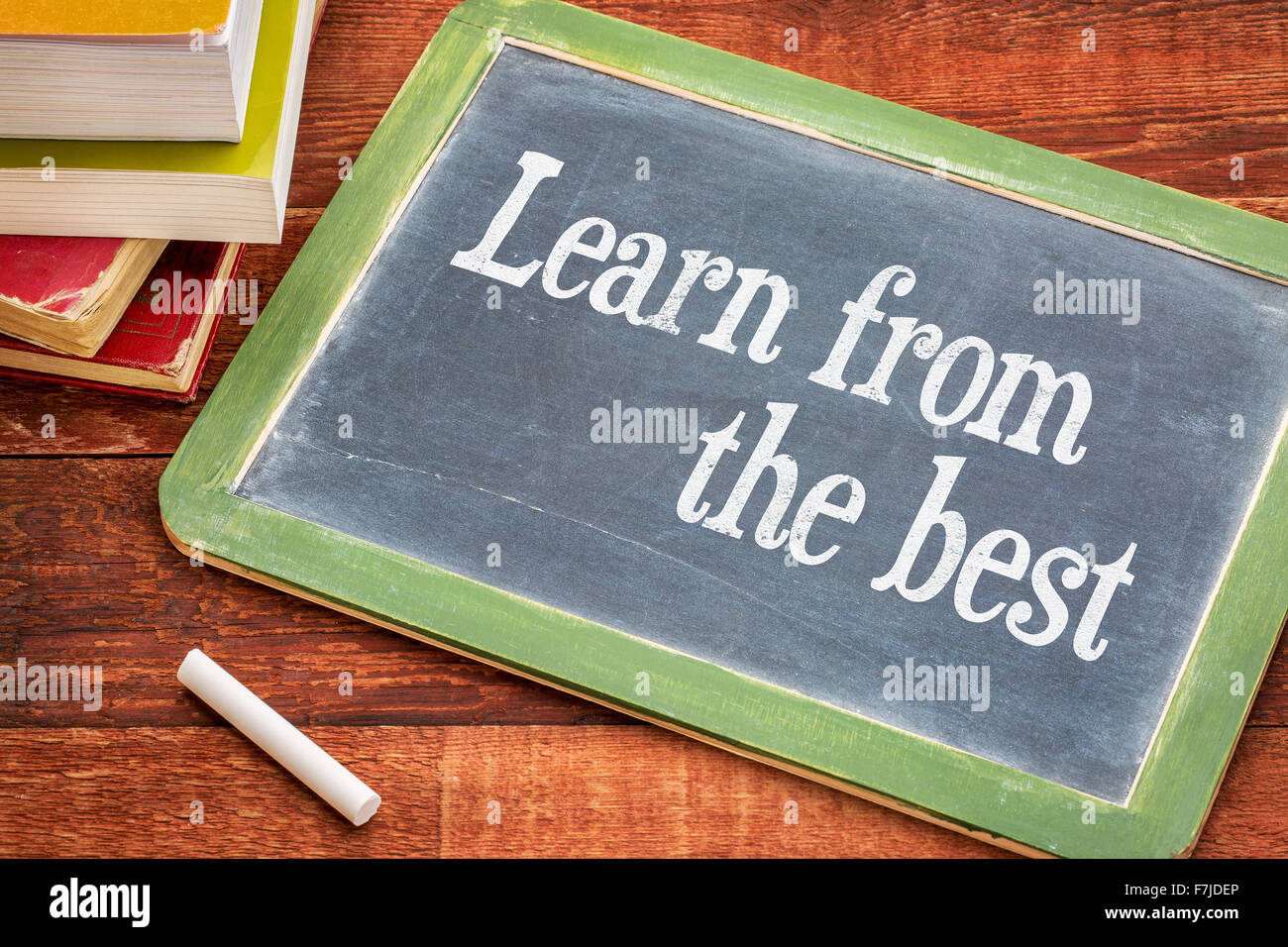 Learn from the best advice - white chalk text on a slate blackboard ...