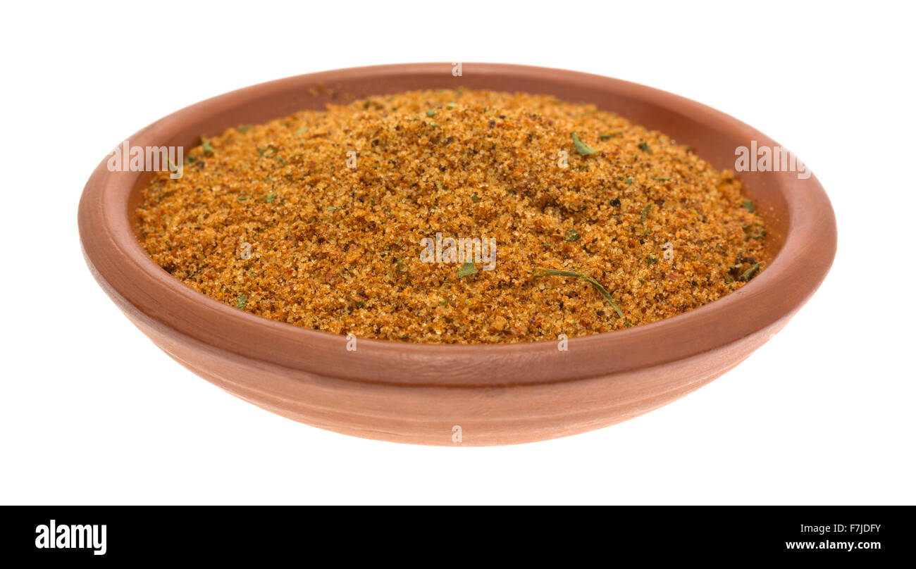Side view of a small bowl filled with dry chipotle pepper marinade ...