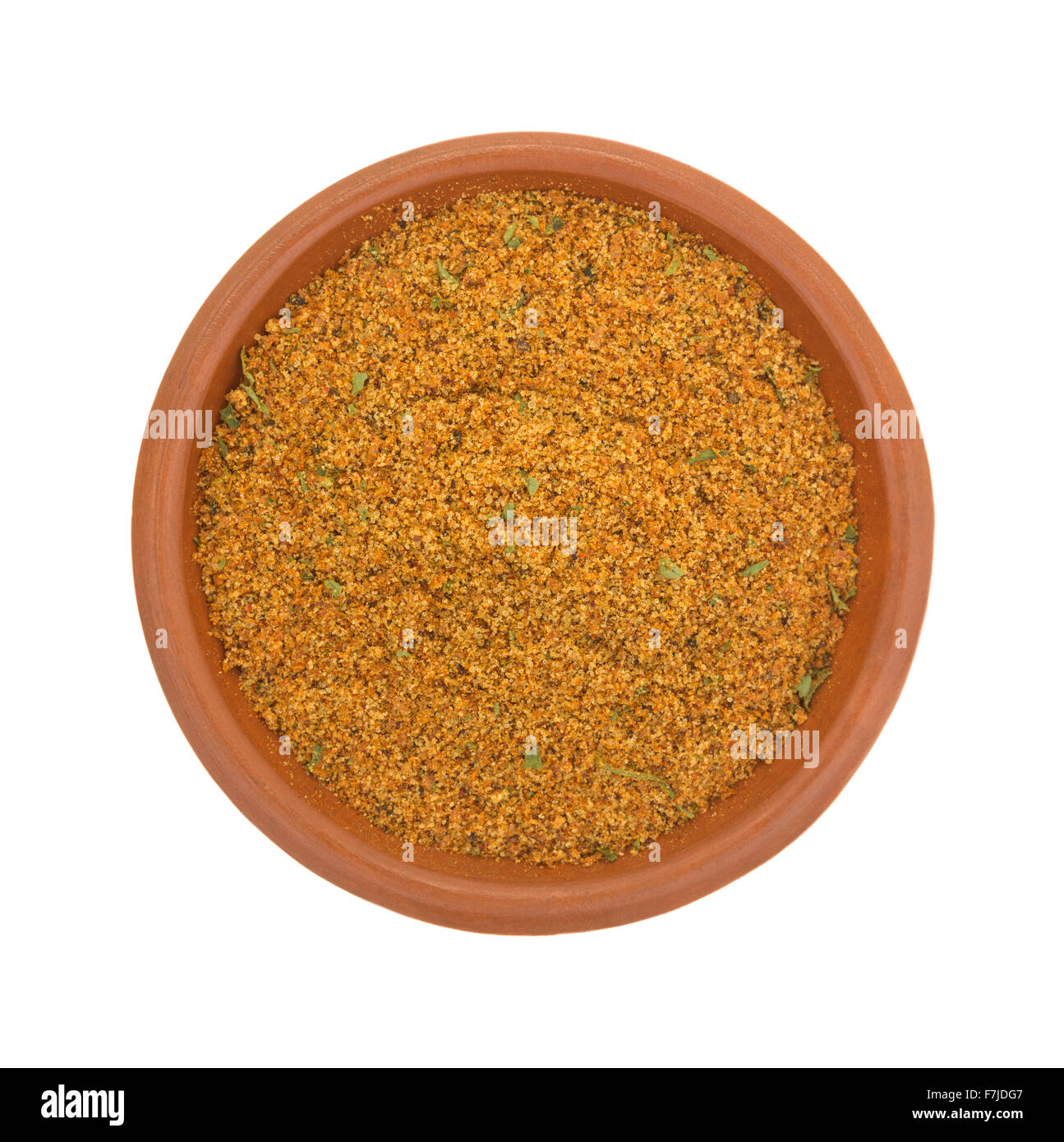 Top view of a small bowl filled with dry chipotle pepper marinade ...