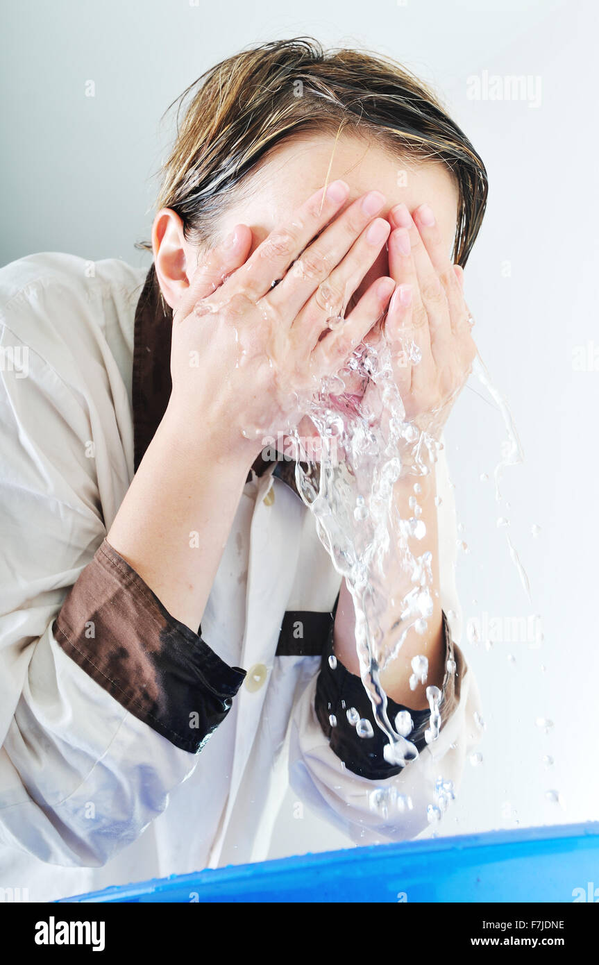 bautiful young woman wash face with clean water isolated on white in ...