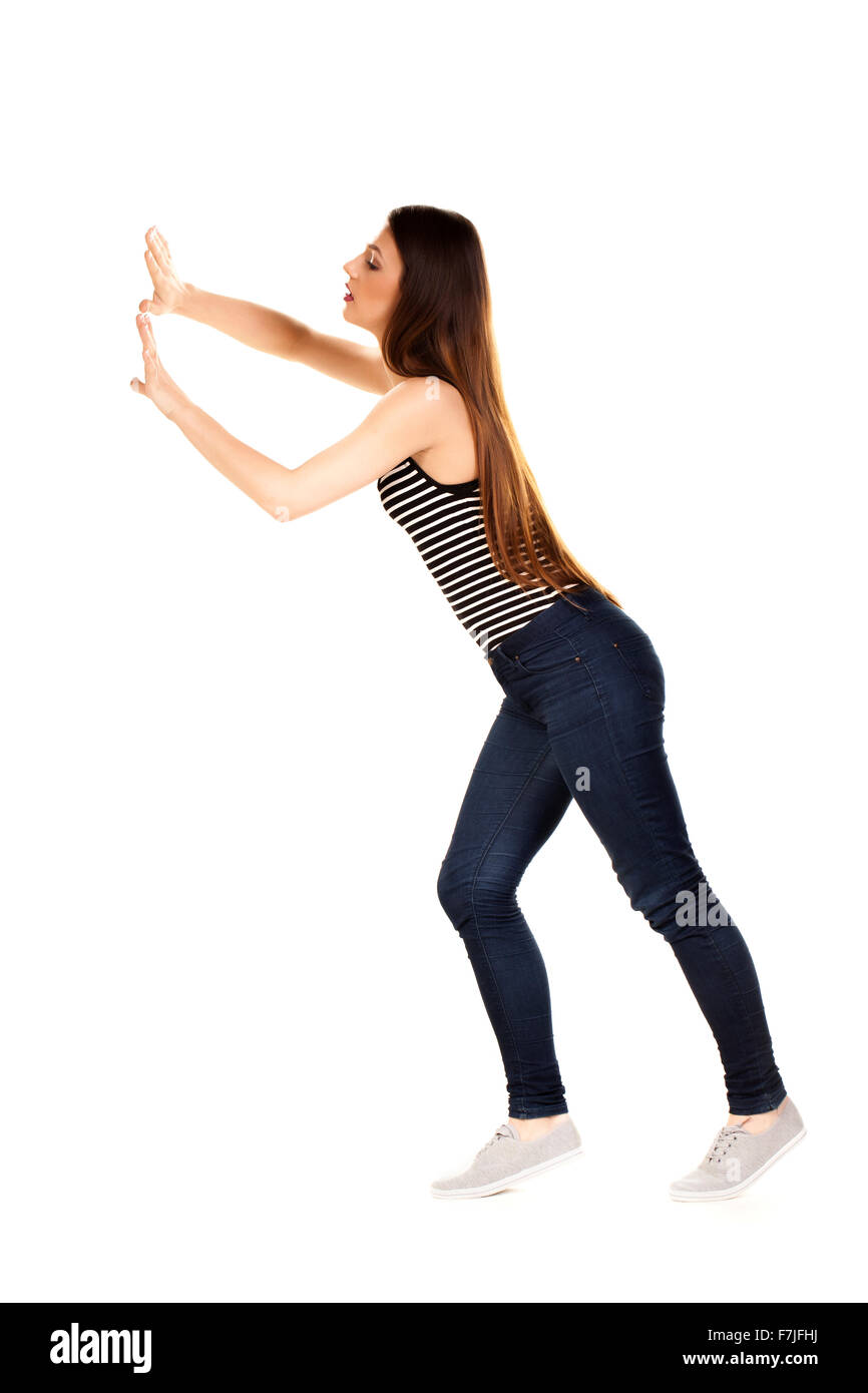 Woman pushing something imaginary isolated over a white background ...