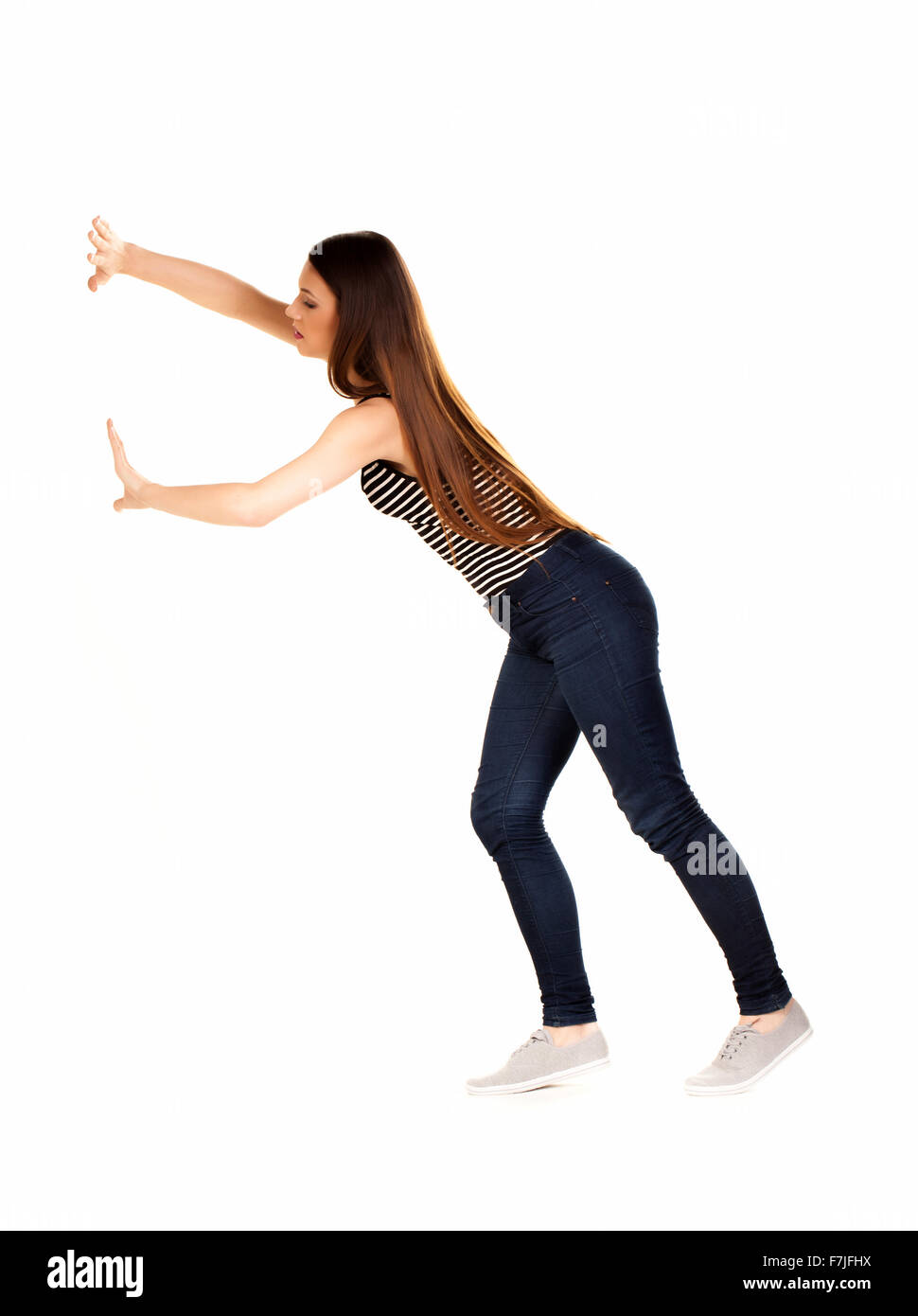 Woman pushing something imaginary isolated over a white background ...