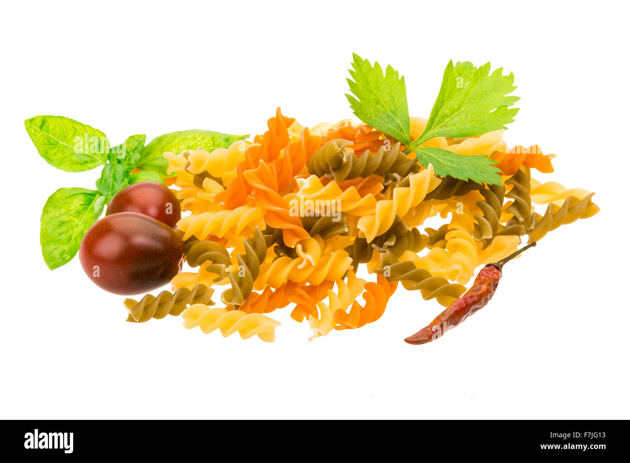 Macaroni - various color with herbs and tomato Stock Photo - Alamy