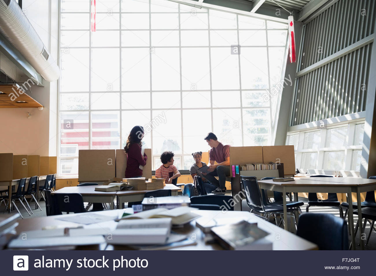 High school students talking in library Stock Photo - Alamy