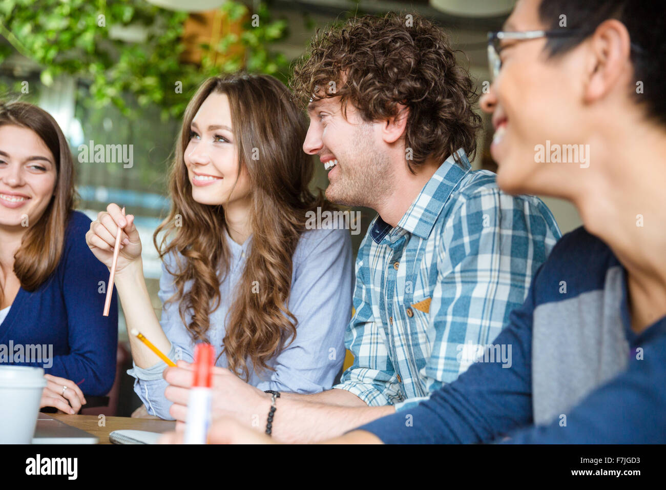 Positive cheerful students studying together and smiling Stock Photo ...
