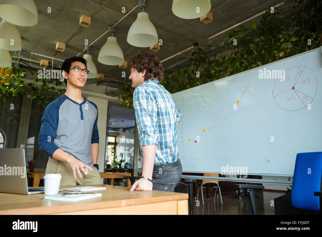 Young concentrated pleased man talking hi-res stock photography and ...