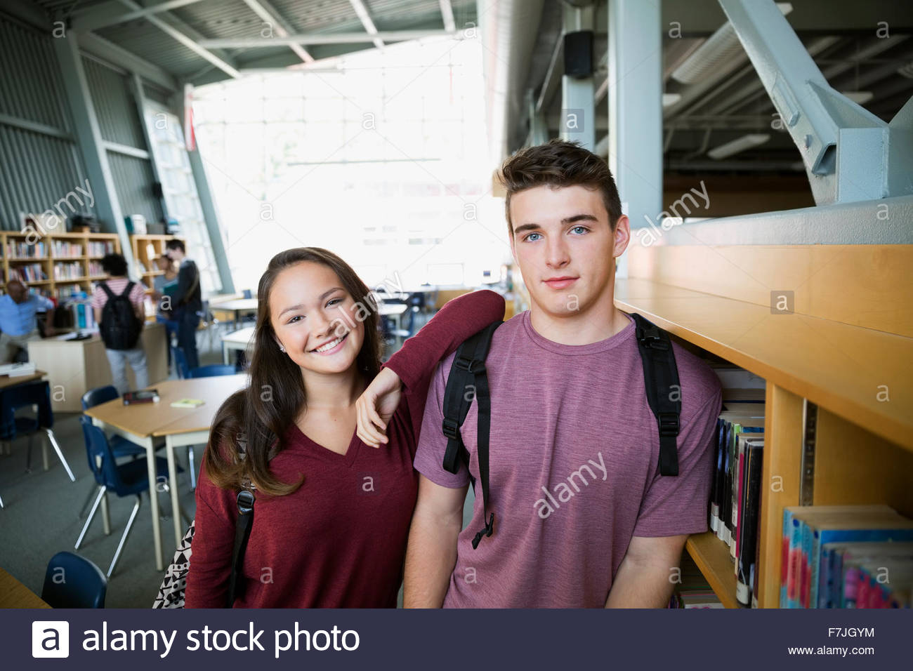 Portrait confident high school students in library Stock Photo - Alamy
