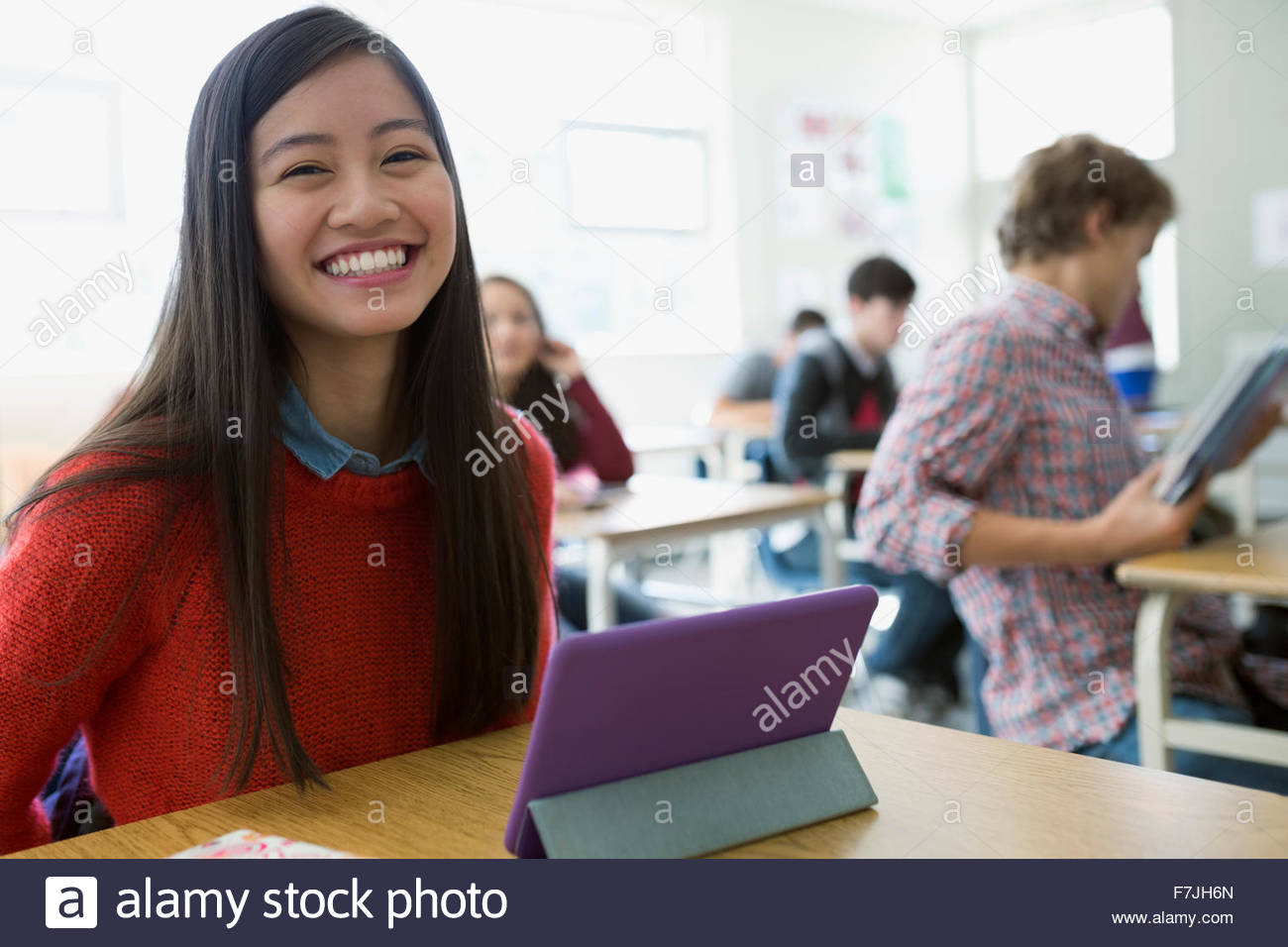Portrait enthusiastic high school student using digital tablet Stock ...