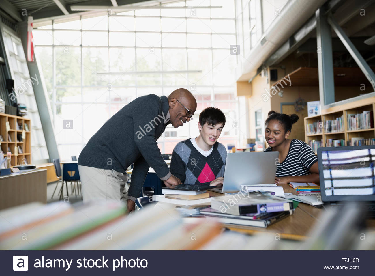 Reading book laptop teacher librarian hi-res stock photography and ...