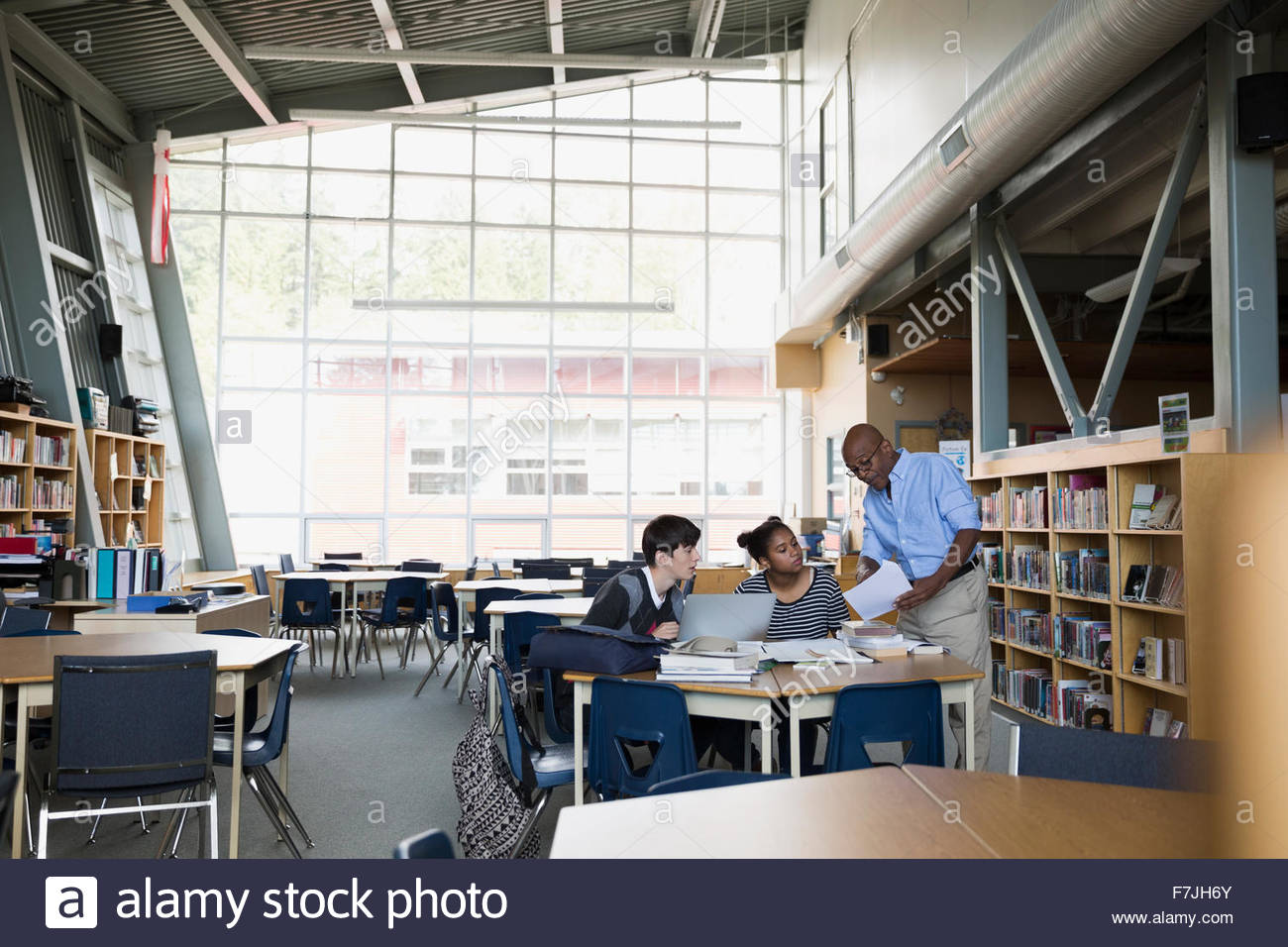 Teacher talking to students in library hi-res stock photography and ...