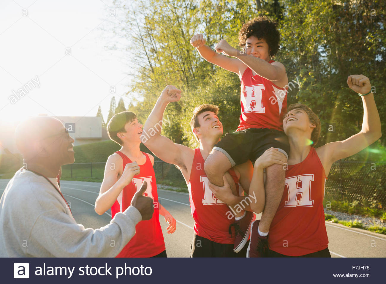 Enthusiastic high school track and field team celebrating Stock Photo ...