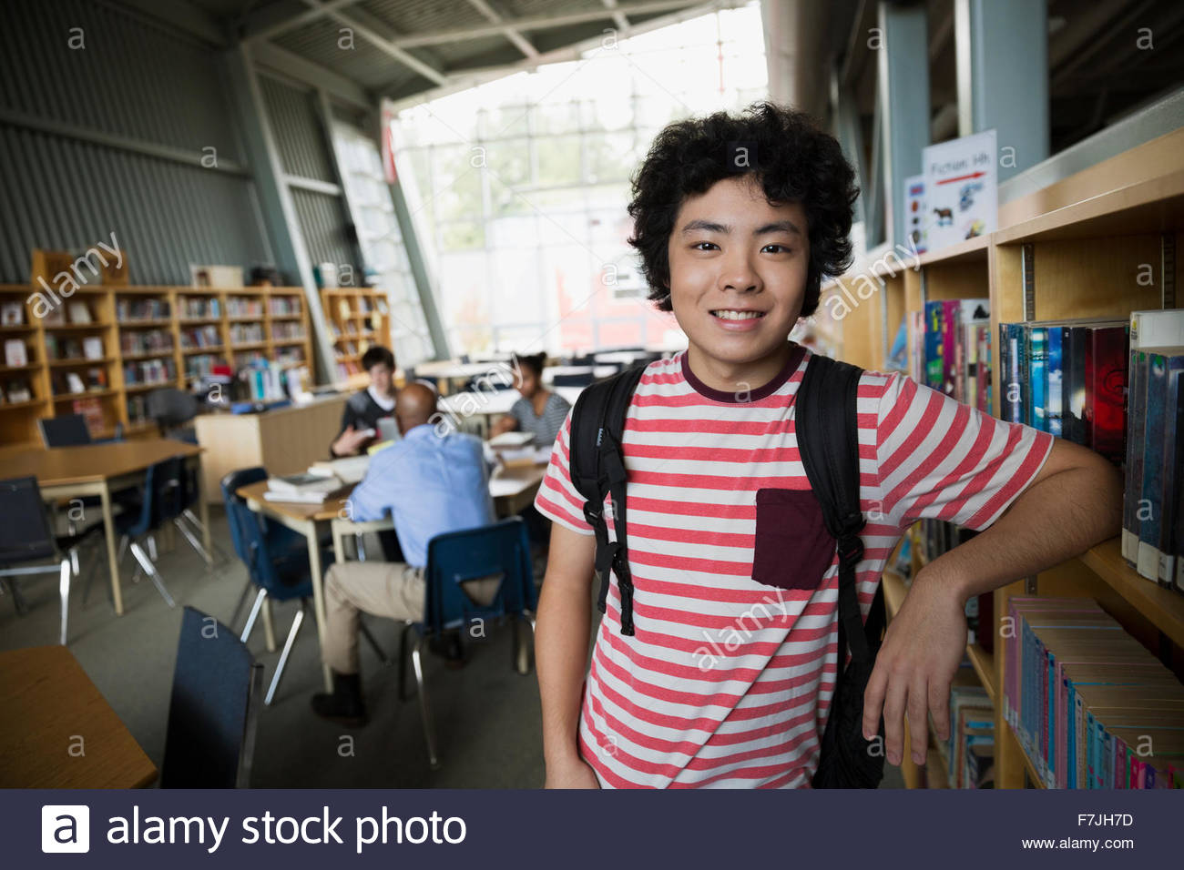 Portrait confident high school student in library Stock Photo - Alamy
