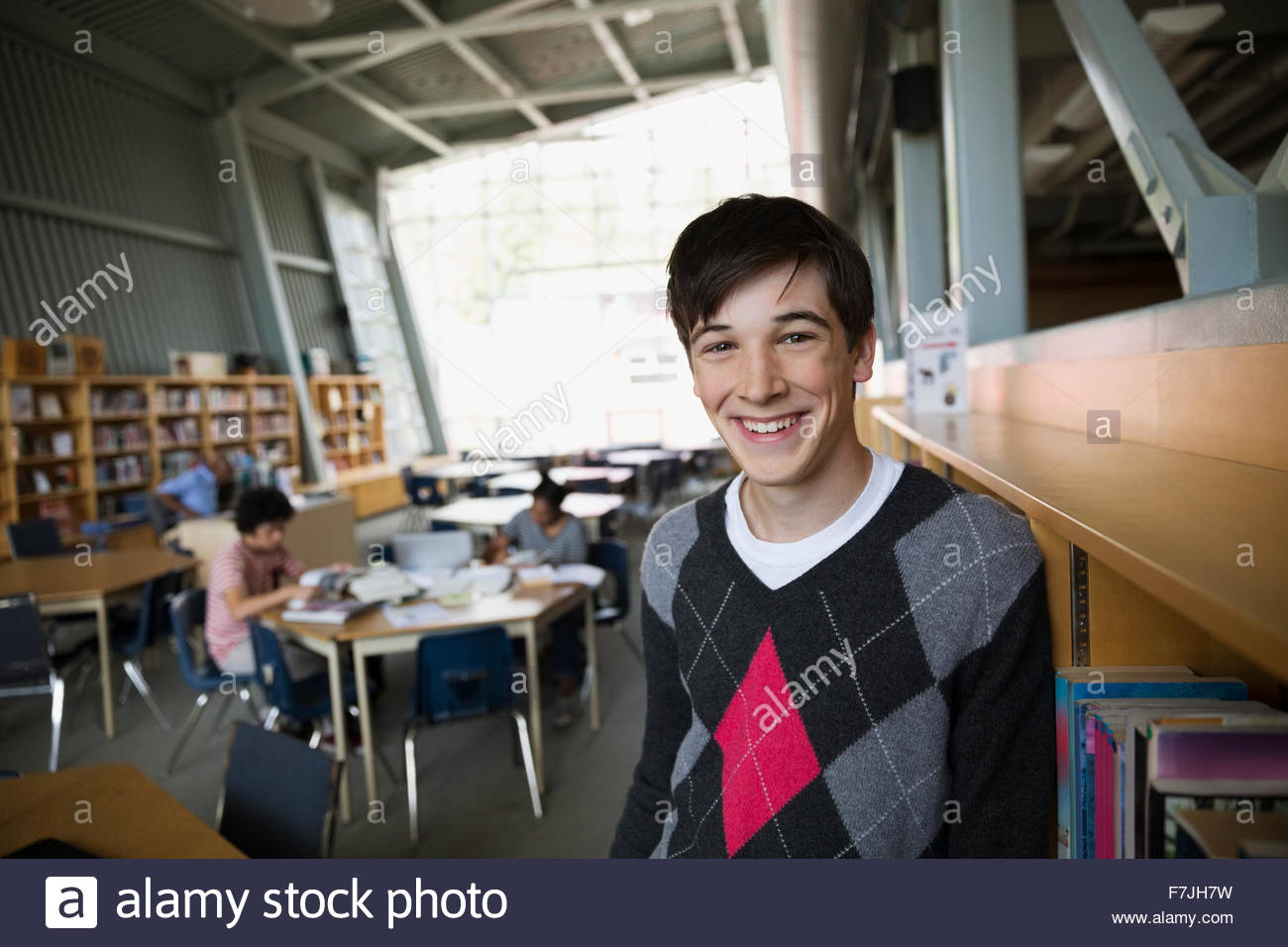 Portrait confident high school student in library Stock Photo - Alamy