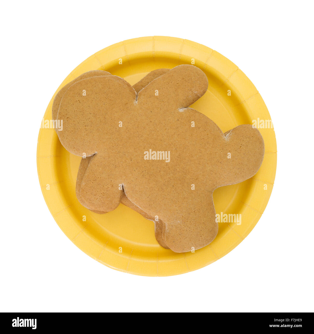 Top view of a stack of freshly baked gingerbread men on a small paper ...