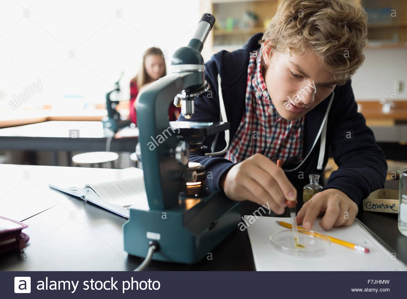 School boy using microscope in hi-res stock photography and images - Alamy