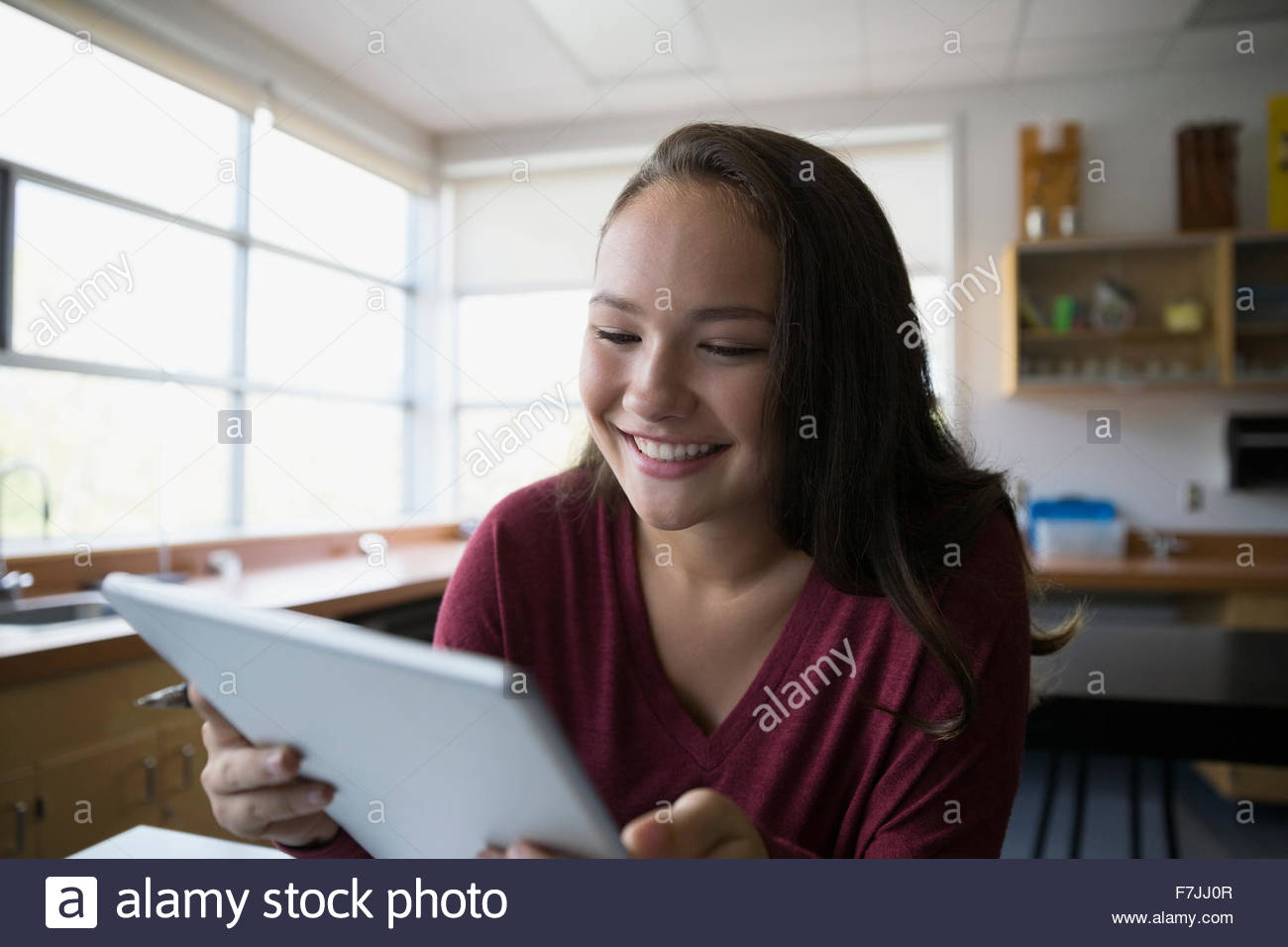 Smiling high school student using digital tablet classroom Stock Photo ...