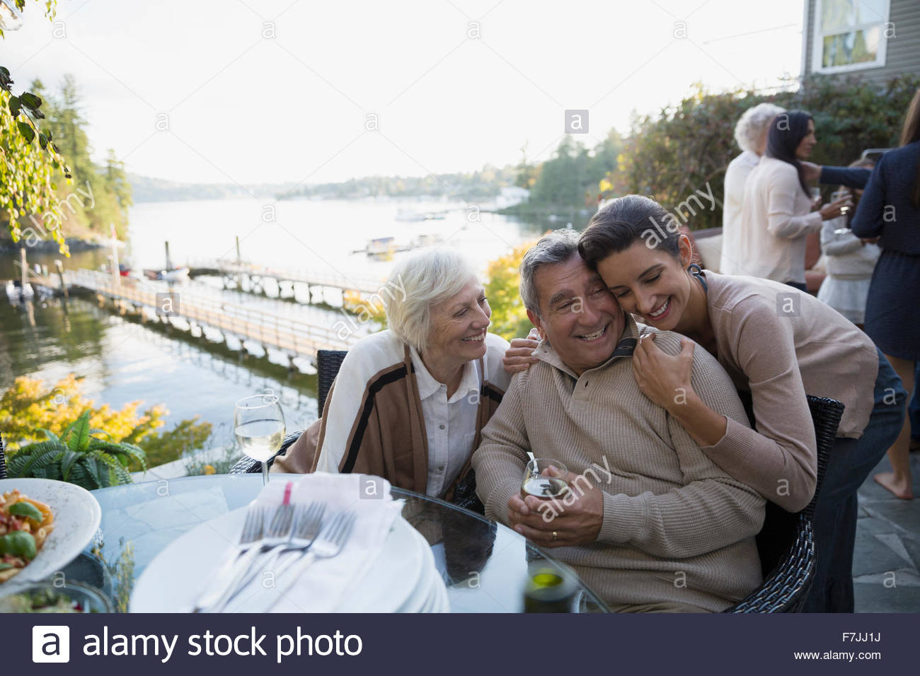 Happy parents hugging daughter outdoors hi-res stock photography and ...