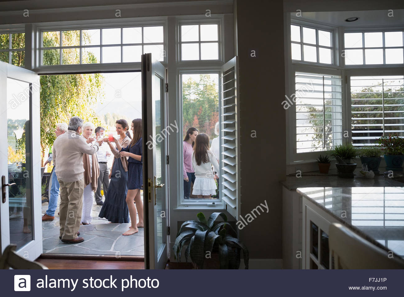 Family socializing on patio Stock Photo - Alamy