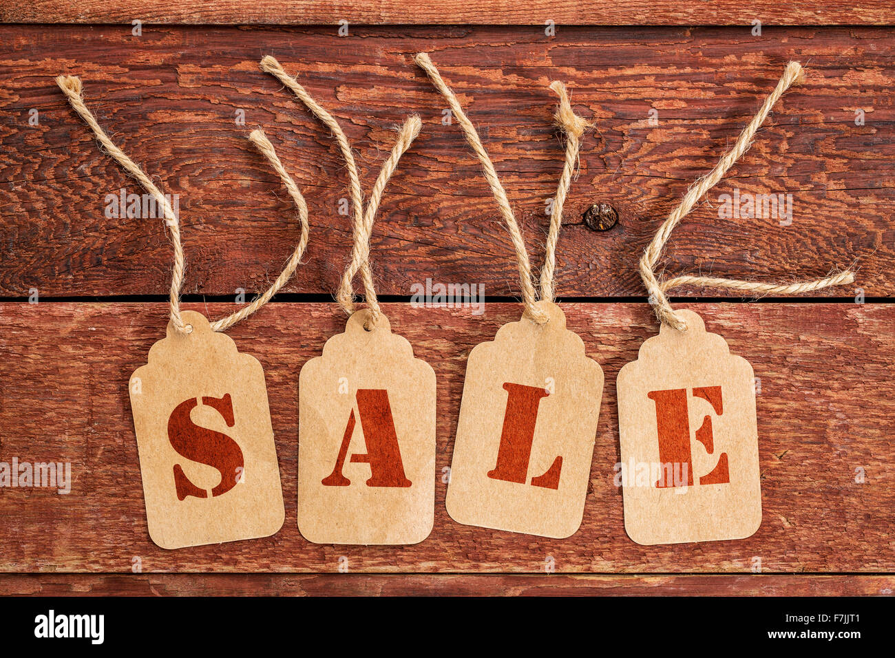 sale sign or concept - letters on price tags against rustic red painted ...