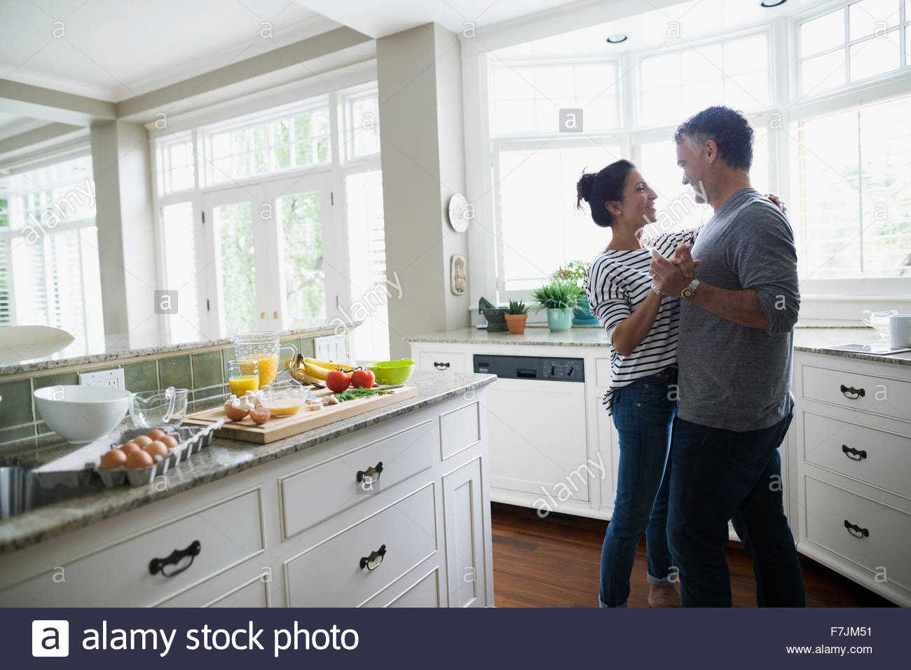 Romantic couple in kitchen hi-res stock photography and images - Alamy