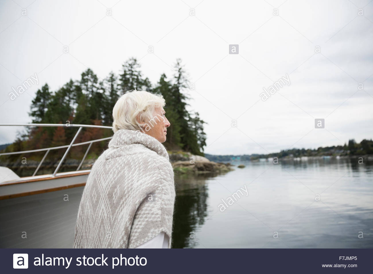 Senior woman looking at lake view Stock Photo - Alamy