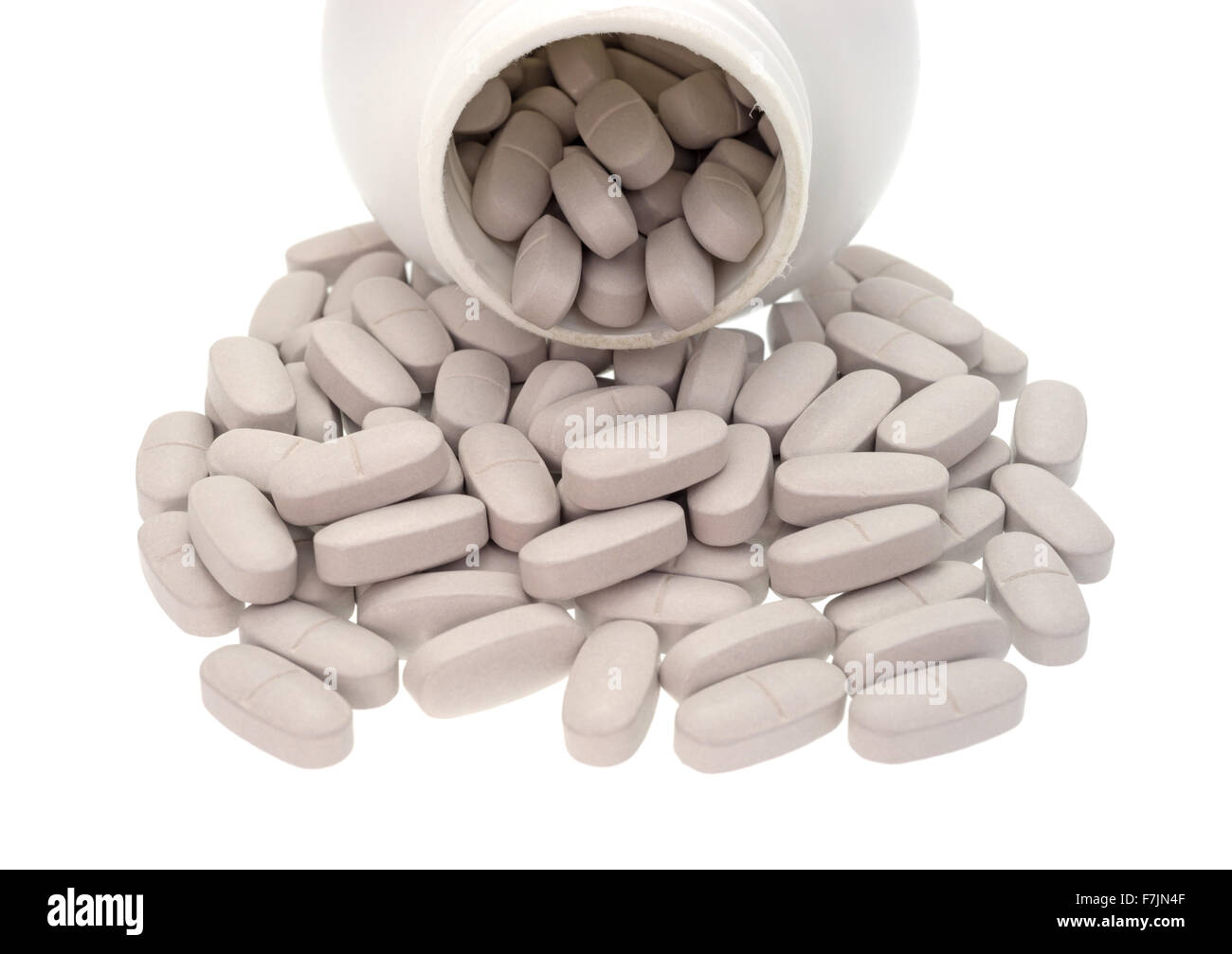 Front close view of daily multivitamins spilling from a plastic ...