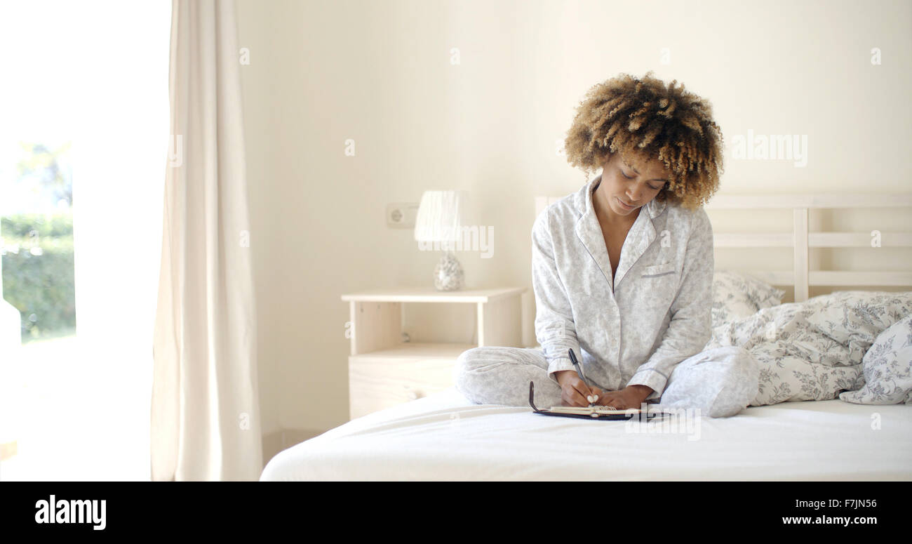 Girl Writes A Diary In Bed Stock Photo - Alamy