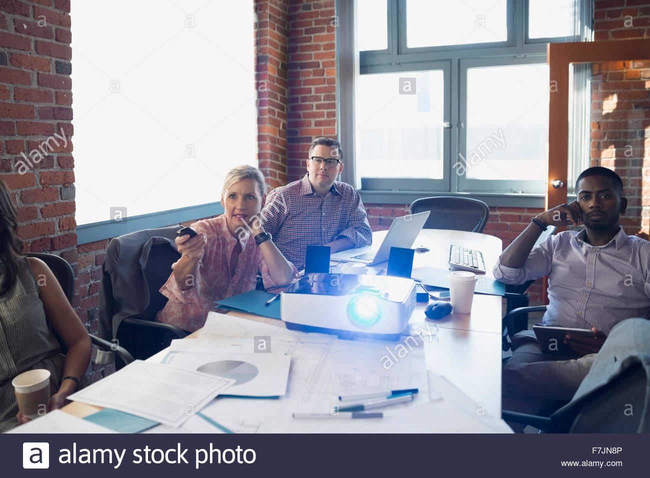 Business people using projector in conference room meeting Stock Photo ...