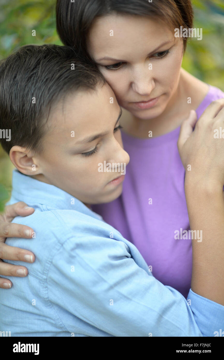 Sad mother with son in park Stock Photo - Alamy