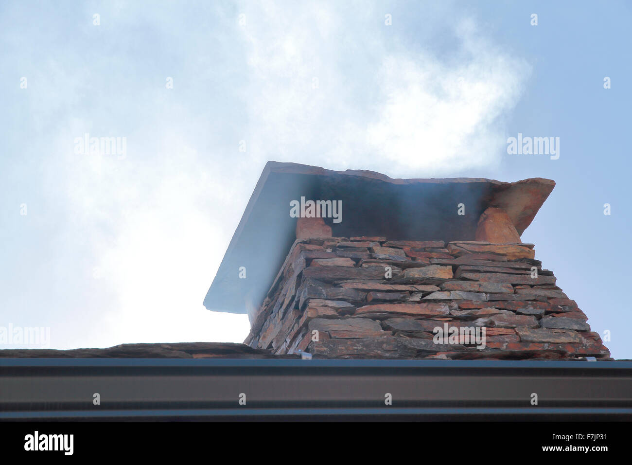 fuming slate chimney with the sky as background. Slate is typical of ...