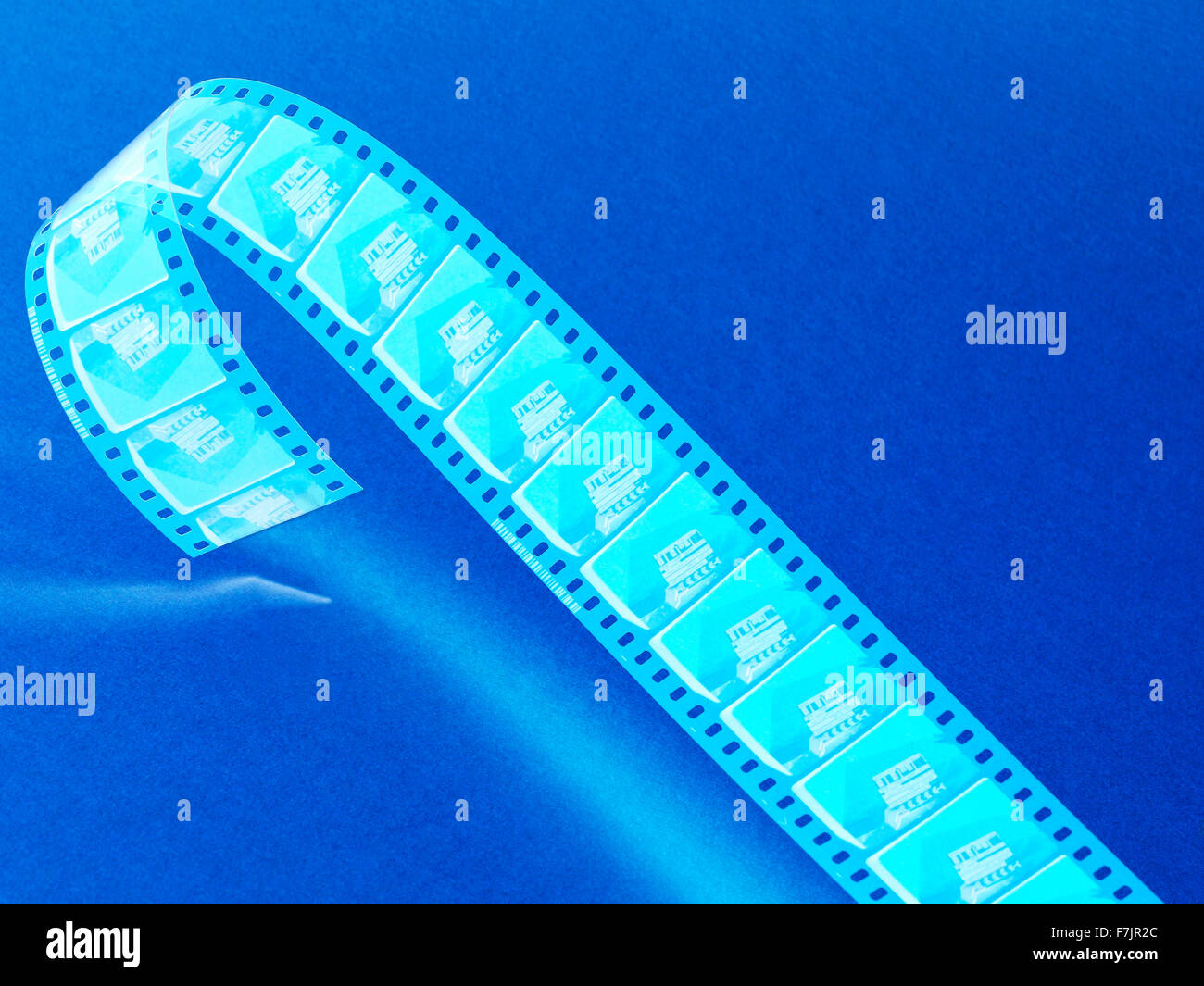 Cinema background negative film reel blue toned Stock Photo - Alamy