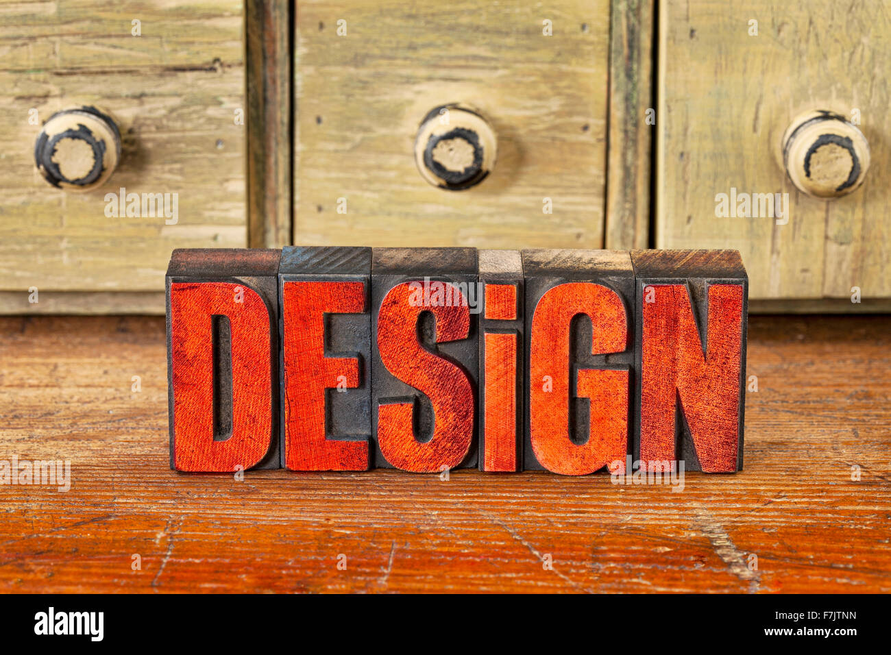 design word in vintage wood letterpress wood type stained by red ink ...