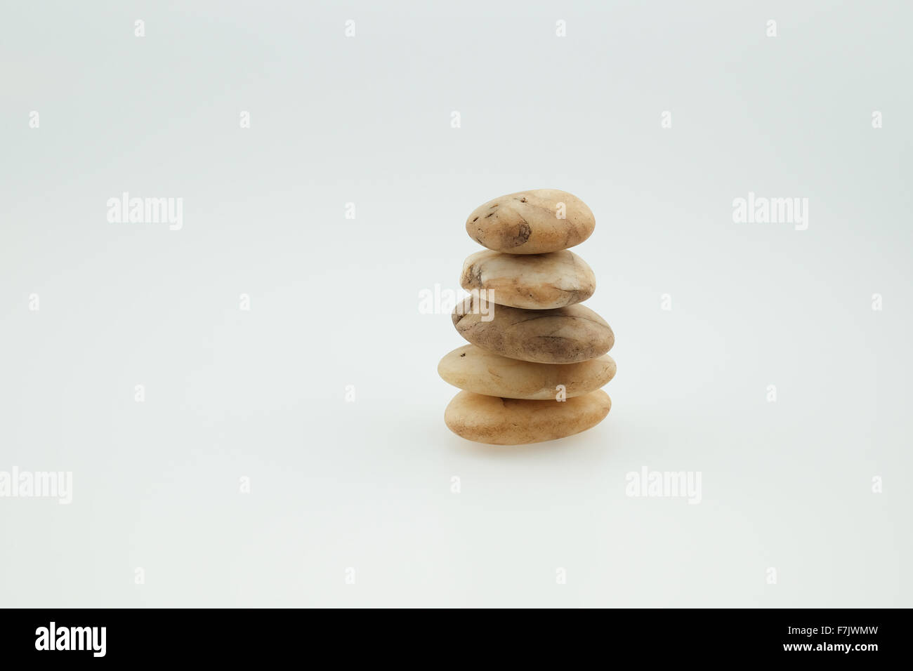 Balanced stacking pebbles, isolated in white background Stock Photo - Alamy
