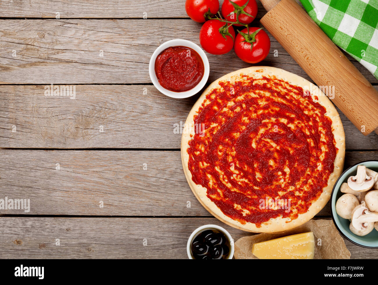 Pizza cooking ingredients. Dough, vegetables and spices. Top view with ...
