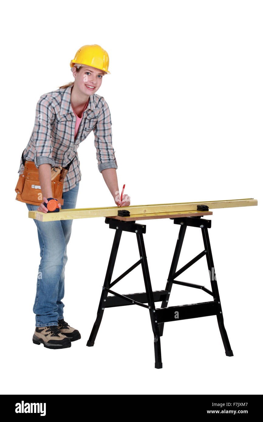 craftswoman measuring a board Stock Photo - Alamy