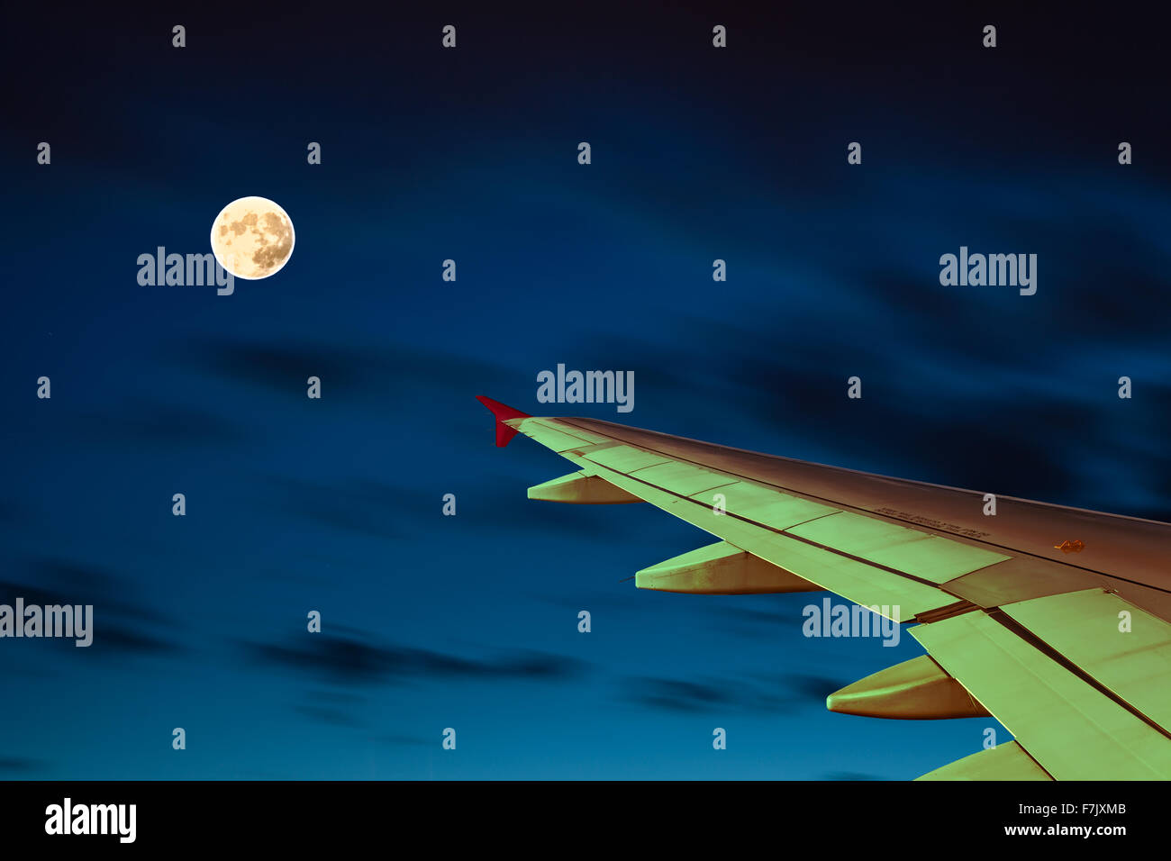 Plane wing in the night sky with an illuminated moon Stock Photo - Alamy