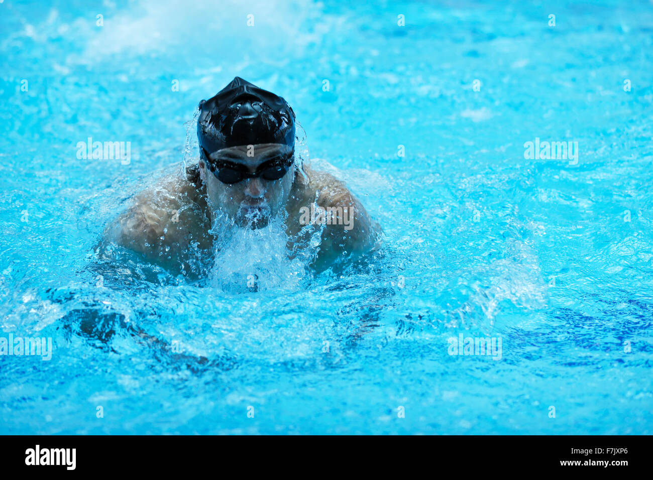 young healthy with muscular body man swim on swimming pool and ...