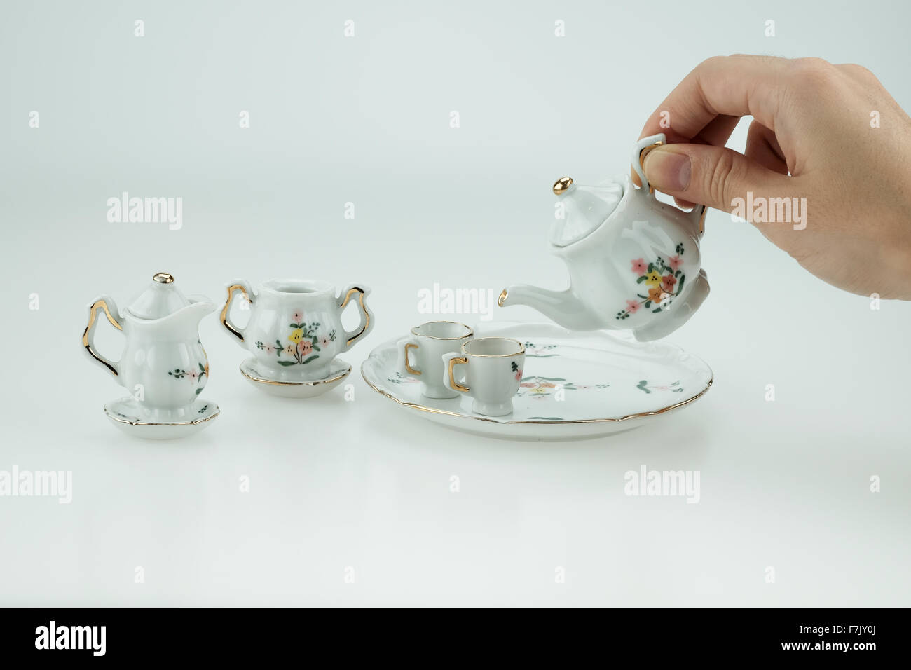 Mini ceramic tea cup set, isolated in white background Stock Photo - Alamy