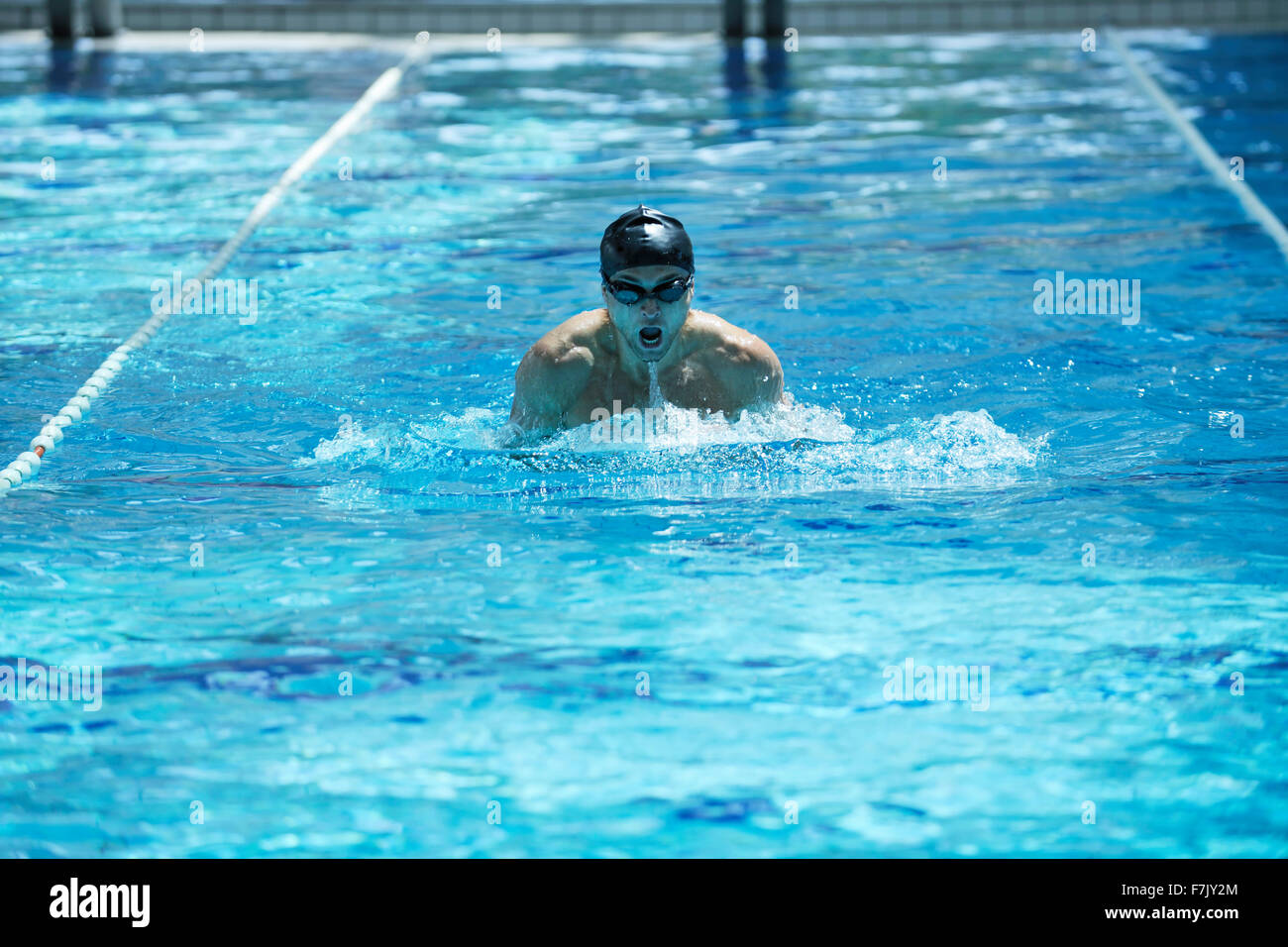 young healthy with muscular body man swim on swimming pool and ...