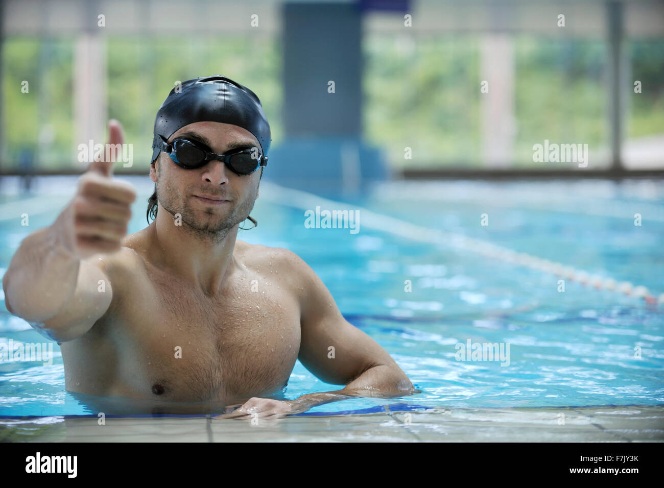 young healthy with muscular body man swim on swimming pool and ...