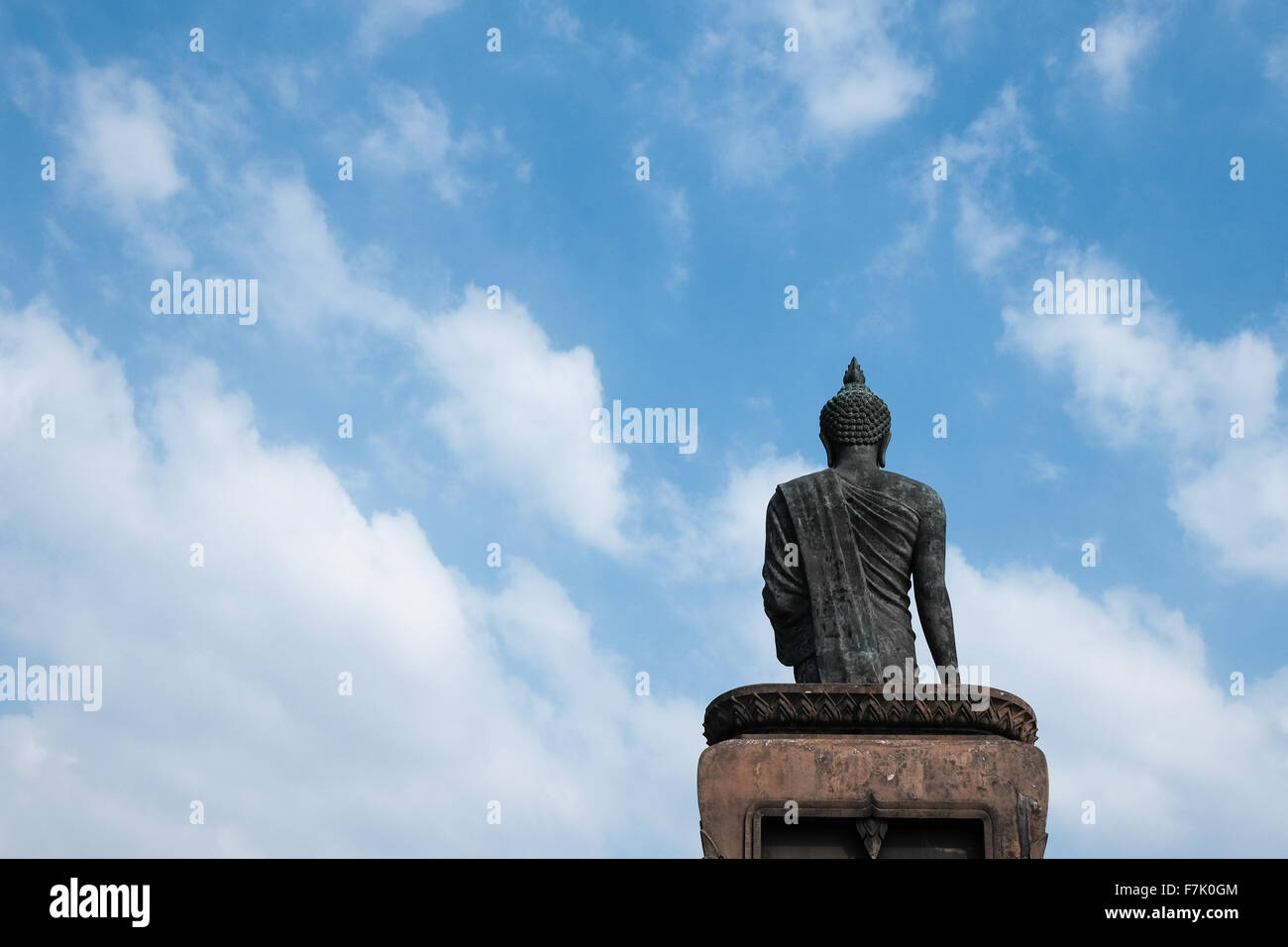 The great Buddha statue in standing pose, viewed from the back with sky ...