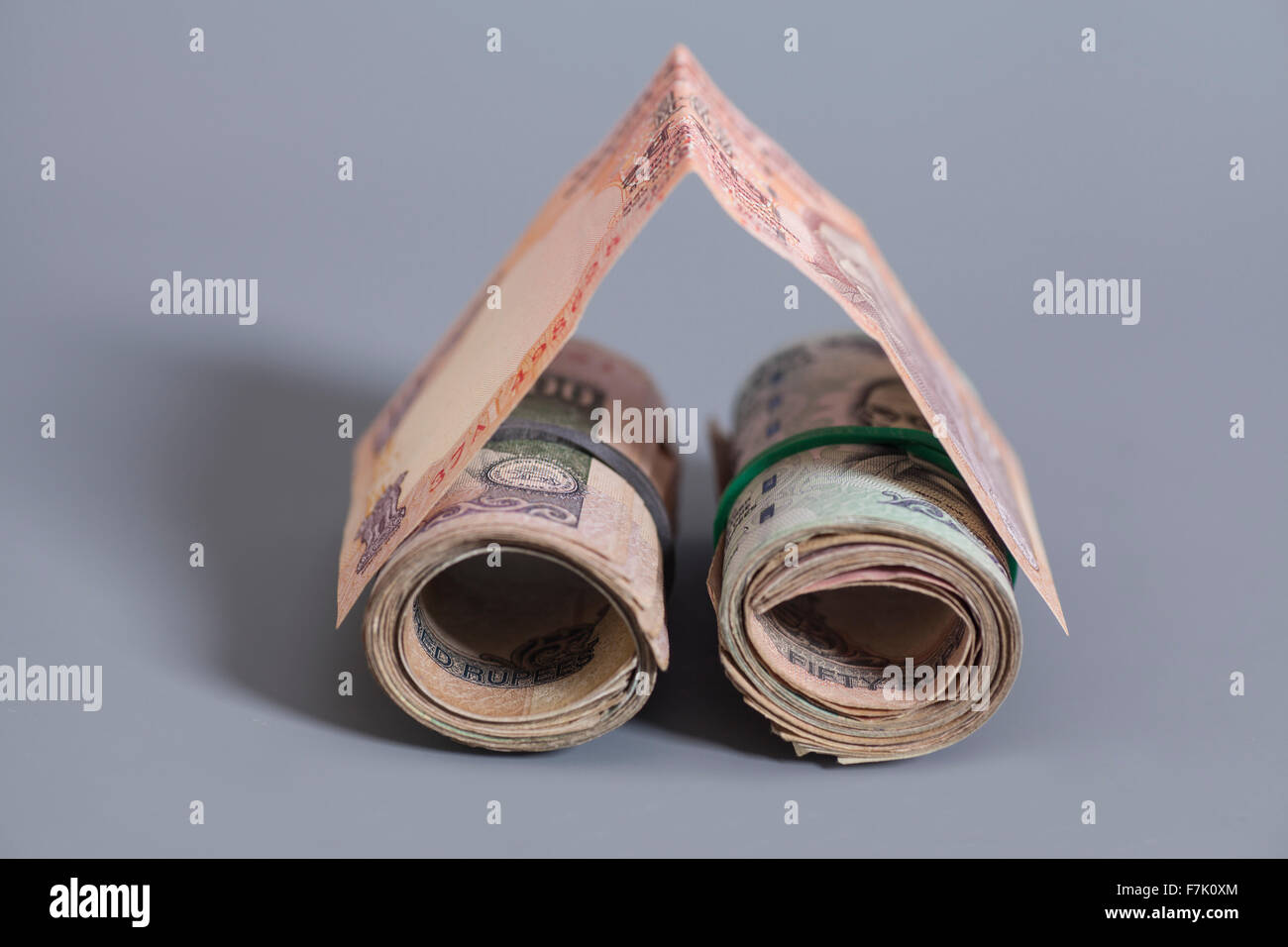 House Made Roll of Indian rupee banknotes isolated on gray Stock Photo ...