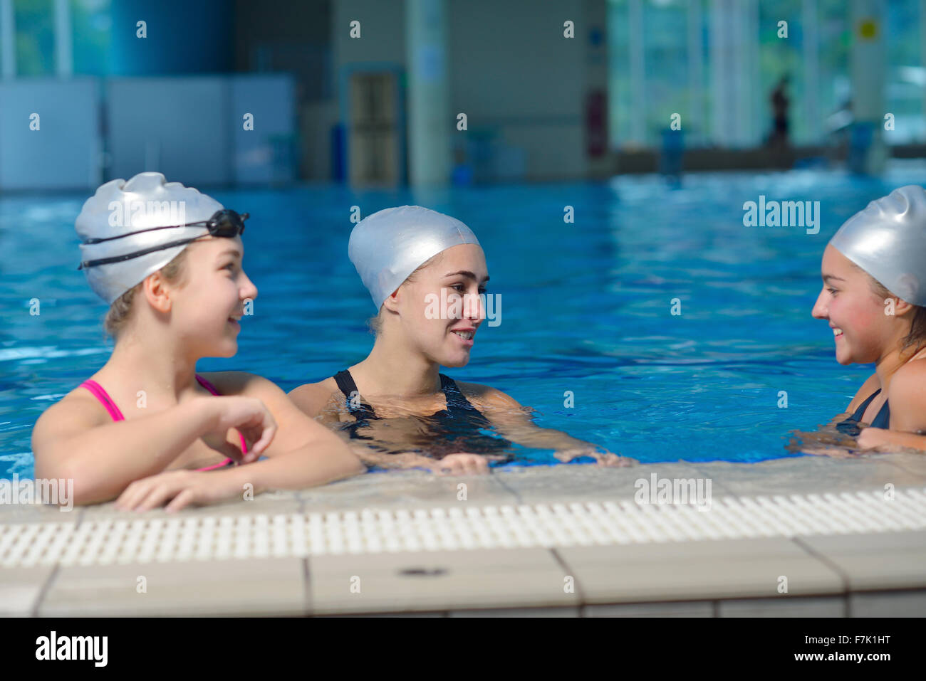 group of happy kids children at swimming pool class learning to swim ...