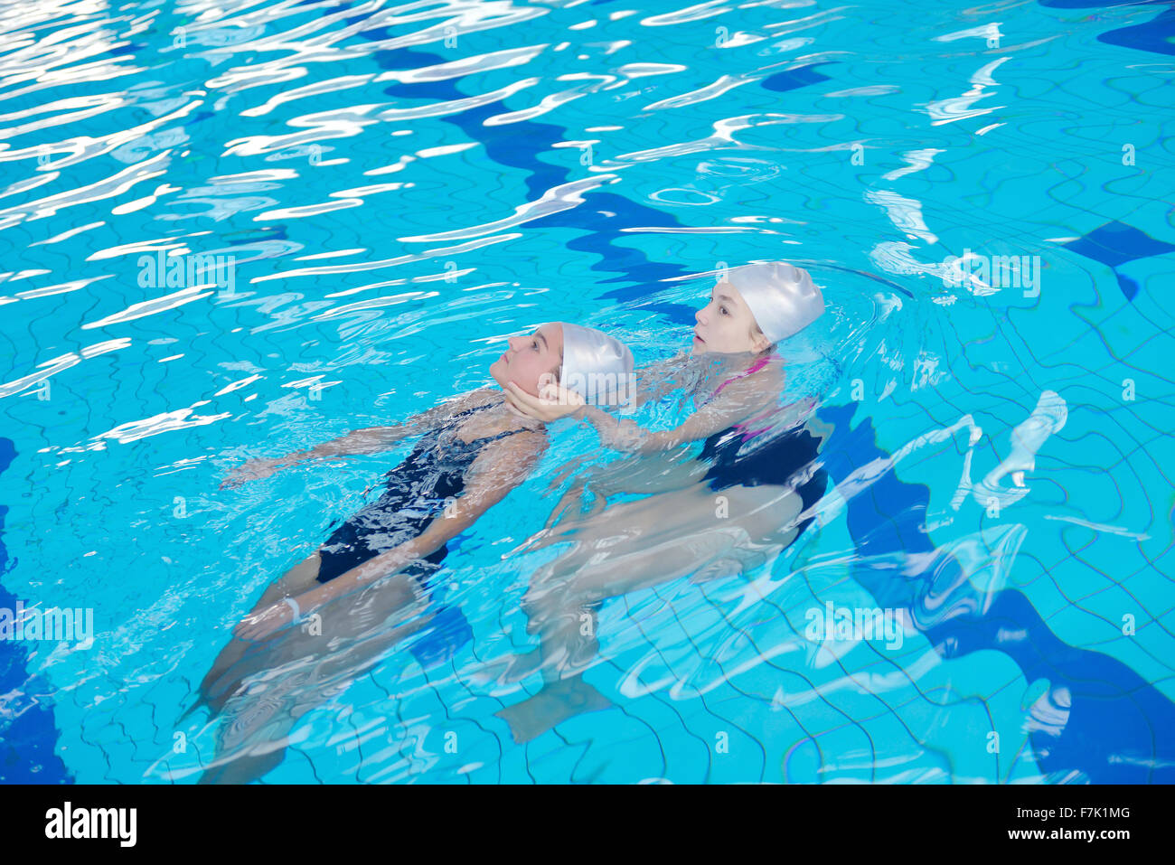help and rescue action in swimming school at pool Stock Photo - Alamy