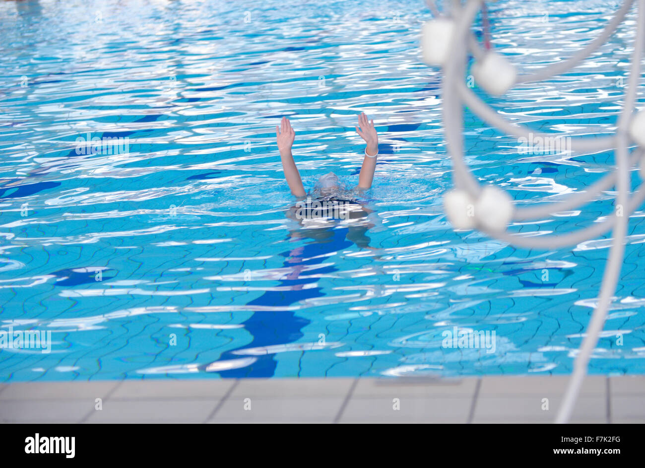 help and rescue action in swimming school at pool Stock Photo - Alamy