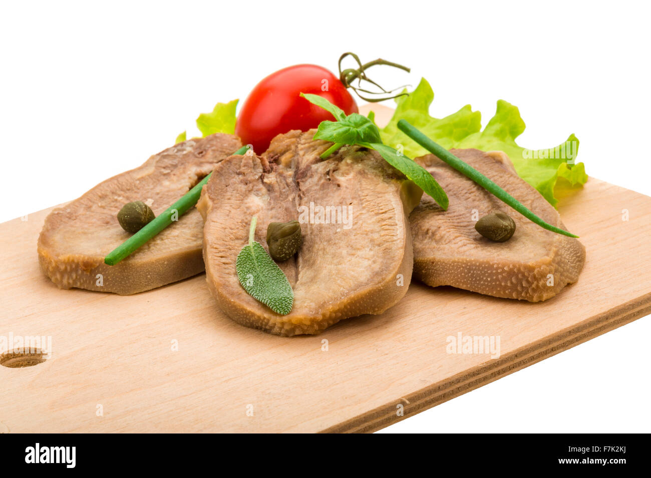 Beef tongue with herbs isolated Stock Photo - Alamy
