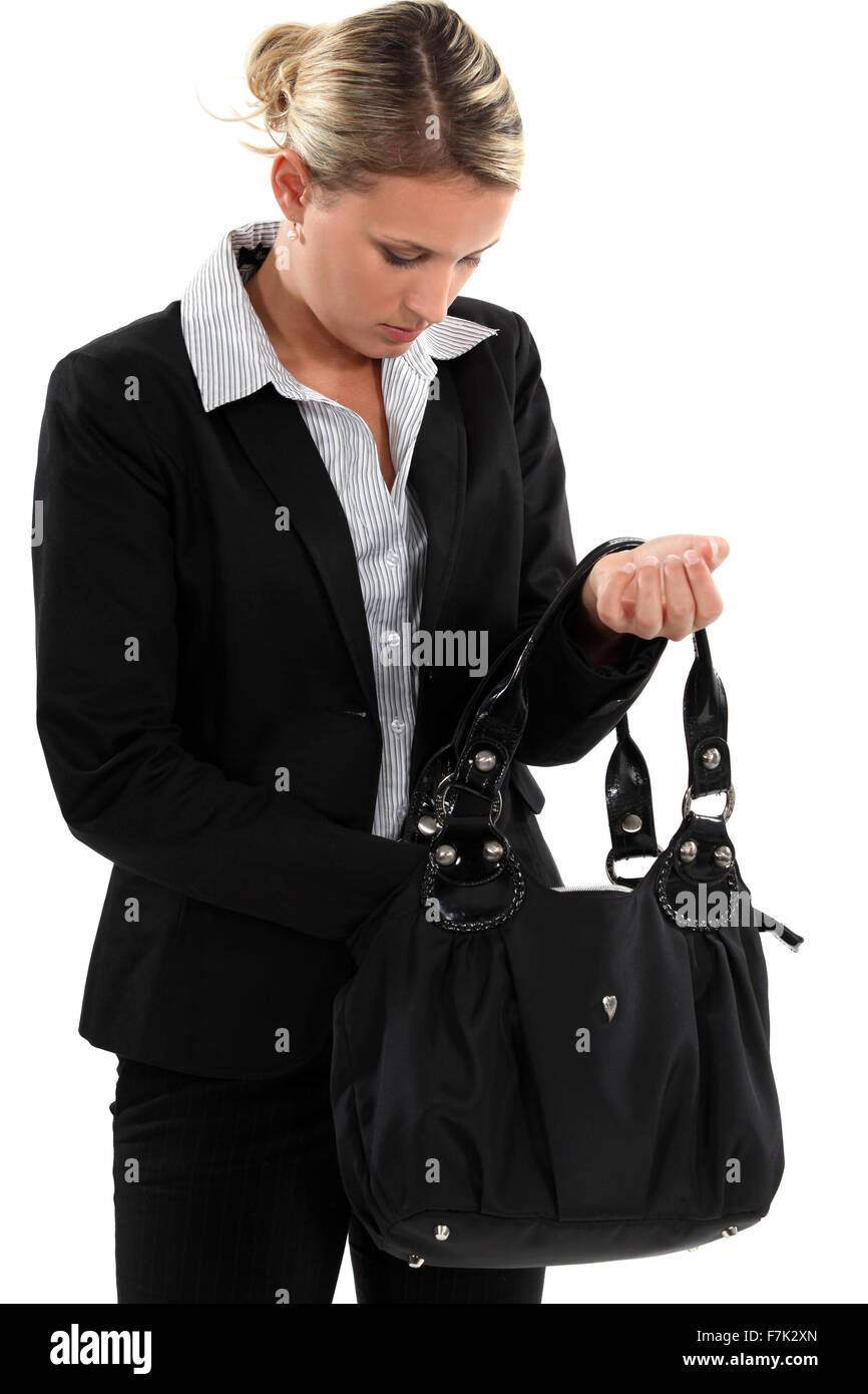 Businesswoman searching through her bag Stock Photo - Alamy