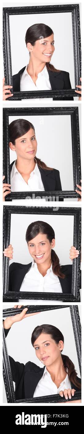 Beautiful woman posing behind frame Stock Photo - Alamy